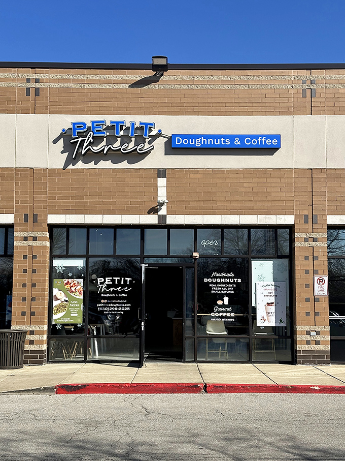 Petit Three's exterior: A beacon of sweetness in Aurora! This modern donut shop's blue signage pops against neutral tones, beckoning sugar lovers from miles around.