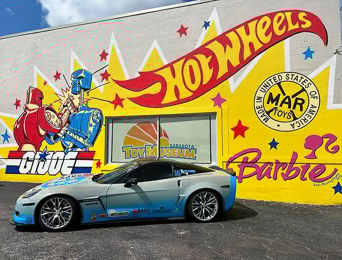 Childhood dreams come to life! This vibrant mural is like a Hot Wheels track come to life, with G.I. Joe and Barbie cheering from the sidelines.