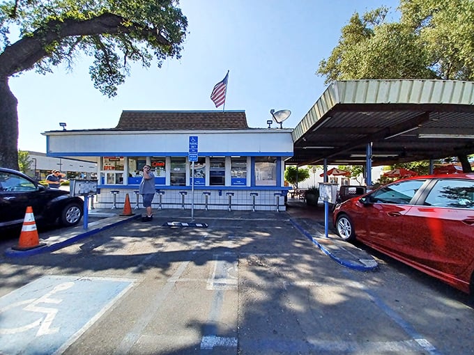 Step back in time! H & W Drive-In's classic blue-and-white exterior is like a portal to the 1950s, complete with a side of nostalgia fries.