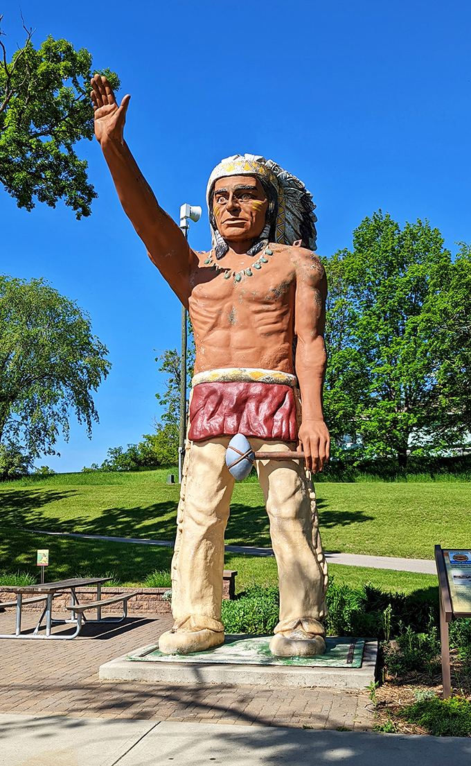 Reaching for the sky or hailing a cosmic taxi? Chief Wenonga's statue stands tall, greeting visitors with an enthusiasm that rivals a Minnesotan welcoming spring.