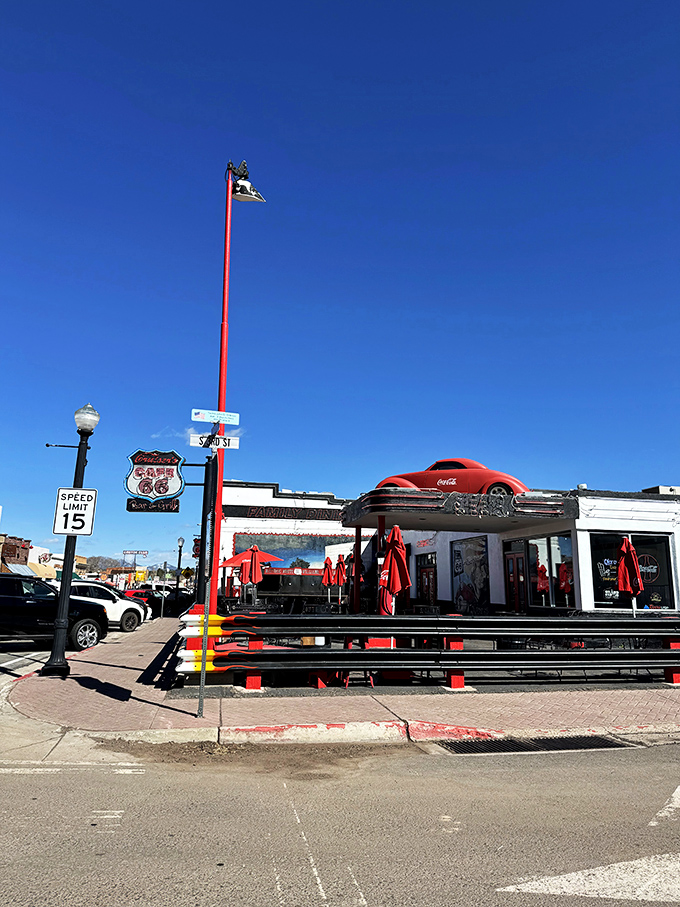 Route 66 nostalgia on steroids! This diner's exterior is a time-traveling feast for the eyes, complete with a cherry-red classic car that's ready to cruise right off the roof.