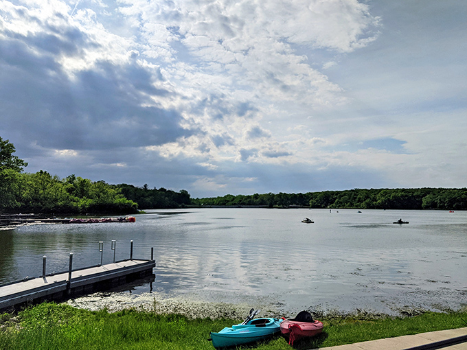 Nature's canvas unfolds: A serene lake view that would make Bob Ross reach for his paintbrush. Fluffy clouds, mirror-like water, and trees galore &ndash; it's like a real-life screensaver!
