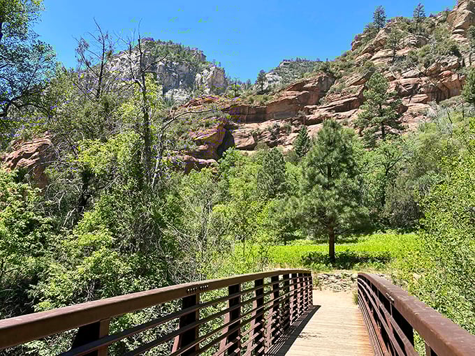 "Nature's red carpet welcome!" This wooden bridge invites you into a world where towering cliffs and lush greenery compete for your attention.