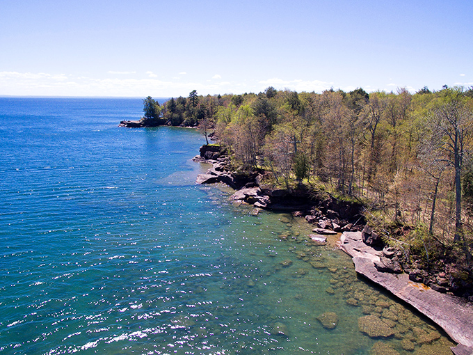 Nature's masterpiece unfolds! Apostle Islands' shoreline is like a Bob Ross painting come to life, minus the "happy little trees."