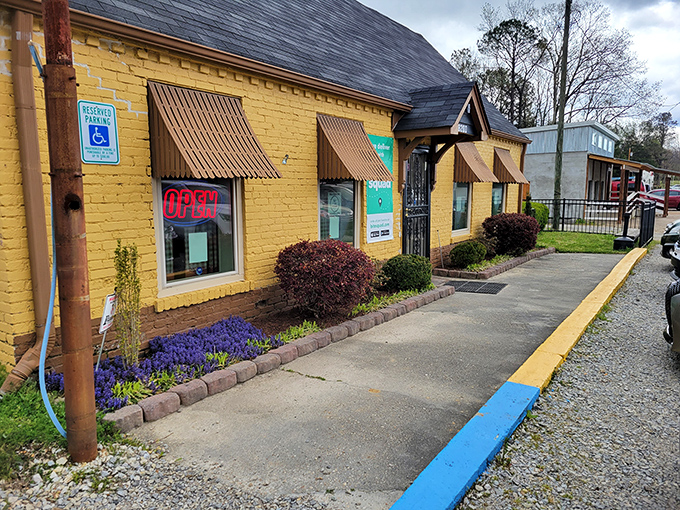 A sunny slice of Southern charm! This cheerful yellow building with its inviting brown awnings is like a warm hug for your taste buds.