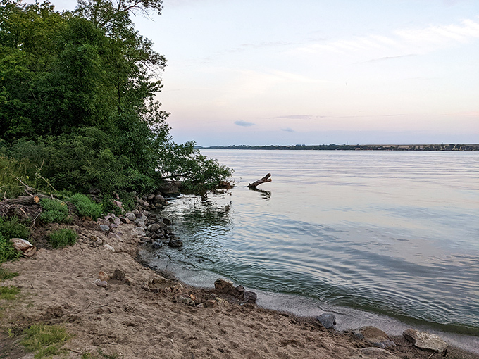 Nature's own infinity pool! The shoreline of Big Stone Lake stretches out like a mirror, reflecting the sky in a display that would make even the most jaded Instagram influencer reach for their camera.