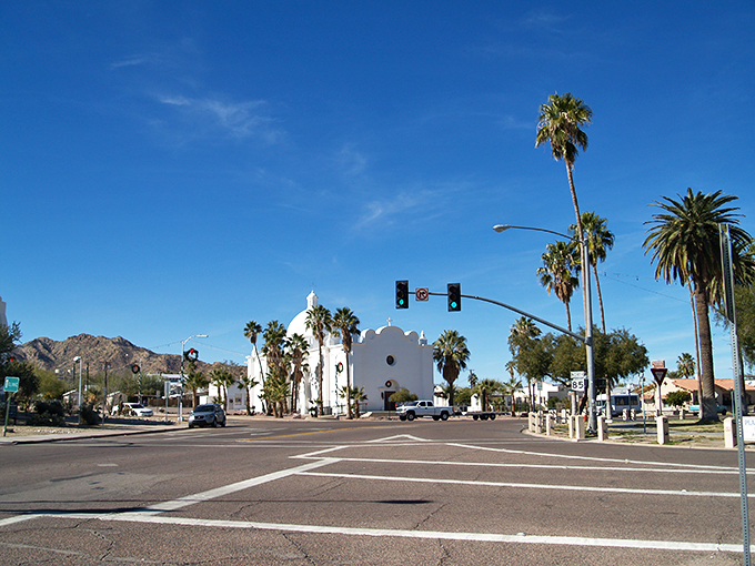 "Holy guacamole, it's a desert oasis!" Palm trees and a pristine white church create a scene straight out of a spaghetti western meets Spanish colonial dream. Ajo's town center is ready for its close-up.