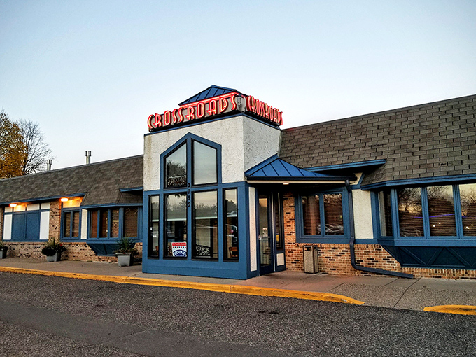 A beacon of deliciousness! Crossroads Delicatessen stands proud, its blue-trimmed windows winking at hungry passersby like a culinary lighthouse guiding you to sandwich nirvana.