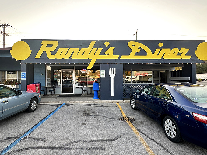 Welcome to breakfast paradise! Randy's Diner's cheerful yellow sign beckons like a sunrise, promising a feast that'll make your taste buds do the happy dance.
