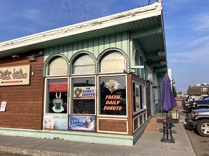 A mint-green time machine! This charming exterior promises a journey back to simpler days when donuts ruled the breakfast kingdom.