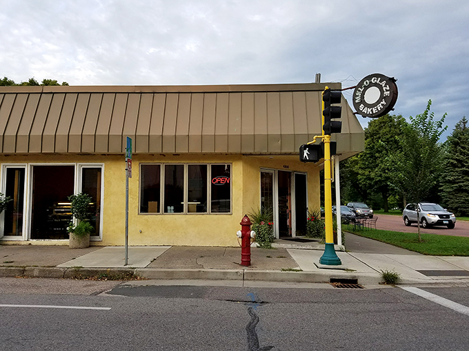A yellow beacon of sugary salvation! Mel-O-Glaze Bakery stands unassumingly on the corner, its retro sign promising sweet delights within. It's like stumbling upon Willy Wonka's secret Midwest outpost.