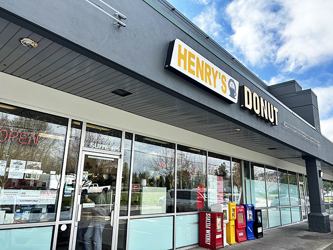Welcome to donut paradise! Henry's Donut stands proud against the Washington sky, promising sweet delights within its unassuming exterior.