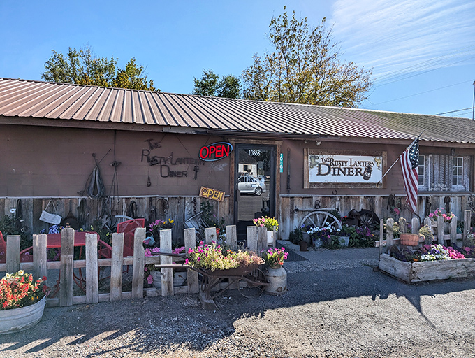 Welcome to the Rusty Lantern Diner, where charm is served in heaping portions! This quaint exterior, adorned with colorful flowers, promises a feast for both eyes and stomach.