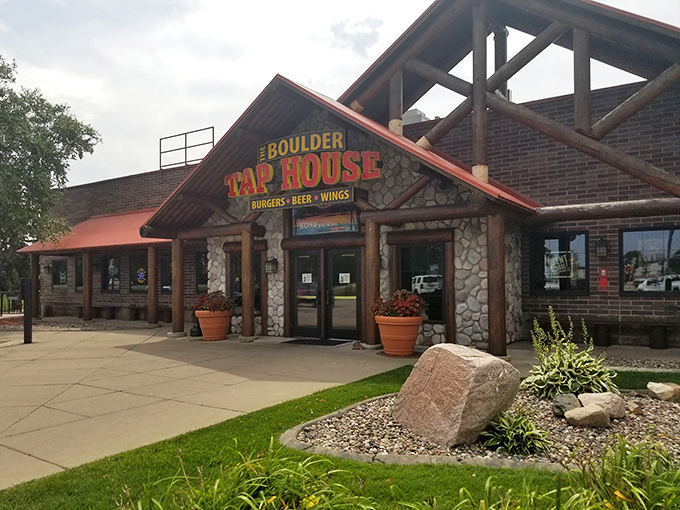 Welcome to Boulder Tap House, where rustic charm meets modern comfort food cravings. This inviting exterior promises a feast for both eyes and taste buds!