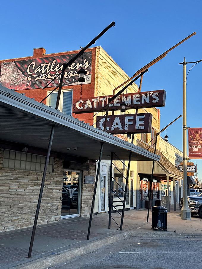 A sign that says "Come for the steak, stay for the history." Cattlemen's iconic exterior beckons meat lovers with its vintage charm and promise of beefy delights.