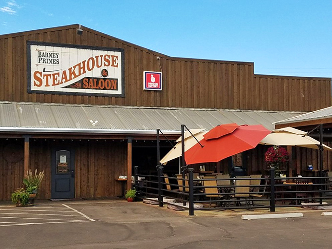 Welcome to beef paradise! Barney Prine's rustic exterior promises a steak-lover's dream, with those red umbrellas beckoning like beacons of deliciousness.