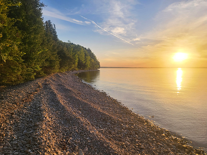 Onaway's hidden treasure: Where pebbled shores meet golden sunsets. This tranquil scene captures the essence of Black Lake's beauty, inviting you to lose yourself in Michigan's secret paradise.