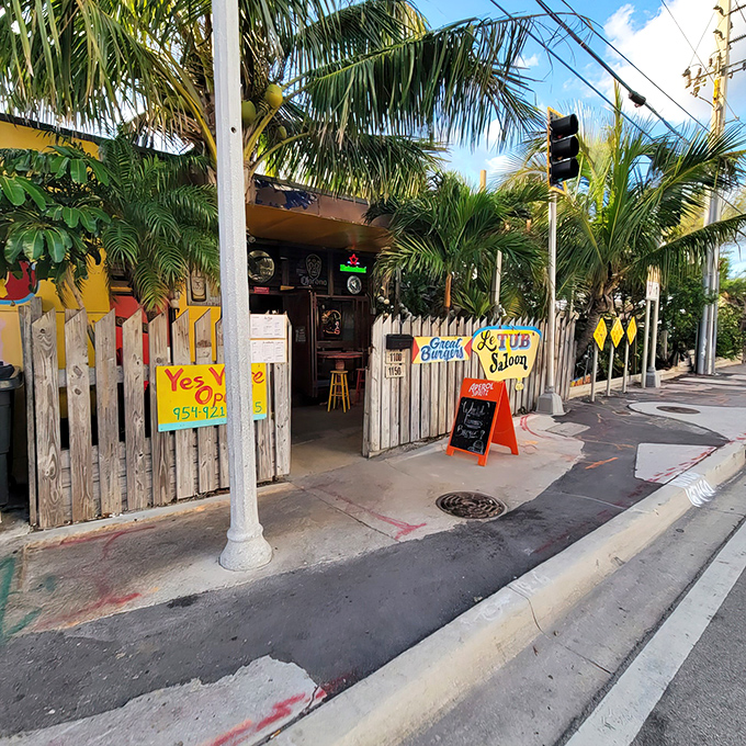 Welcome to Le Tub, where tropical vibes meet culinary magic! This weathered wooden fence guards a treasure trove of flavor and quirky charm.