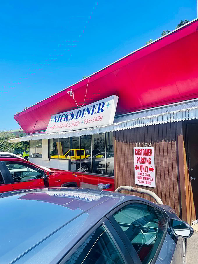 A beacon of breakfast bliss! Nick's Diner's vibrant red exterior is like a siren call to hungry souls, promising comfort food and nostalgia in equal measure.