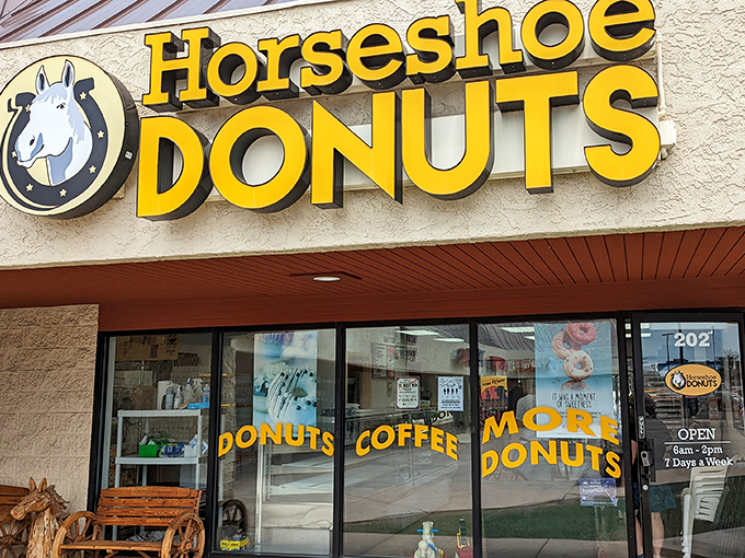A horse of a different color! Horseshoe Donuts' cheerful yellow sign promises a sweet adventure in Monument, Colorado. Giddy up for glazed goodness!