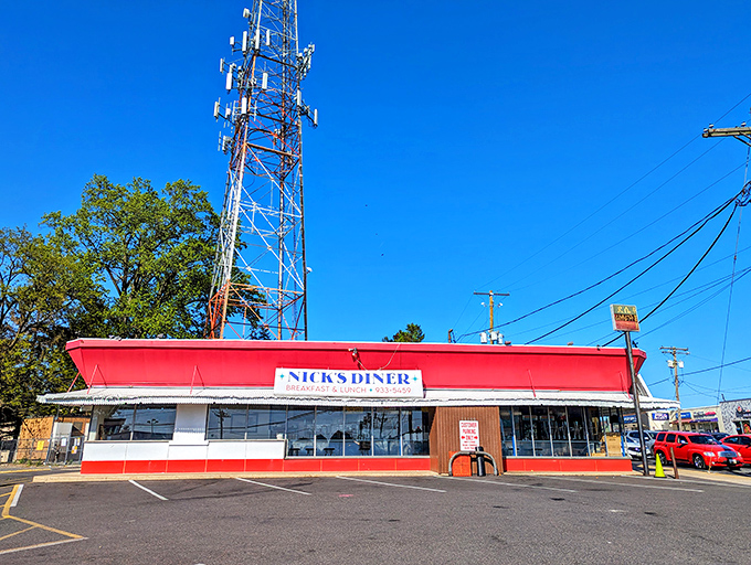 A beacon of breakfast bliss! Nick's Diner's vibrant red exterior is like a siren call to hungry souls, promising comfort food and nostalgia in equal measure.