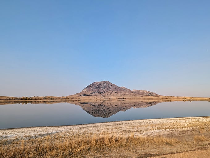 Nature's skyscraper! Bear Butte rises from the prairie like a geological exclamation point, daring you to explore its rugged slopes and hidden stories.