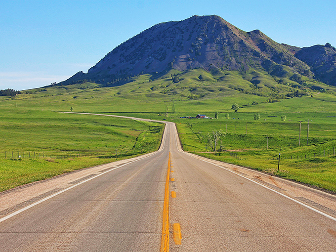 Nature's skyscraper! Bear Butte rises from the prairie like a geological exclamation point, daring you to explore its rugged slopes and hidden stories.