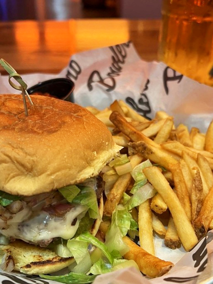 Holy cow, that's a burger! This towering masterpiece could feed a family of four or one very determined bowler.