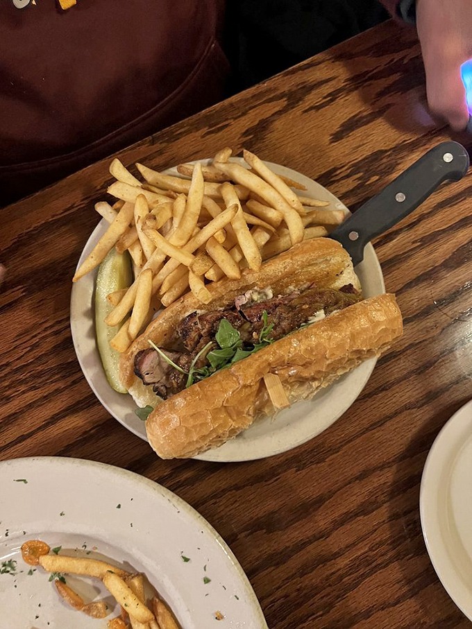 The pork tenderloin sandwich: Where the meat refuses to be contained by mere bread. A Midwest classic, supersized!