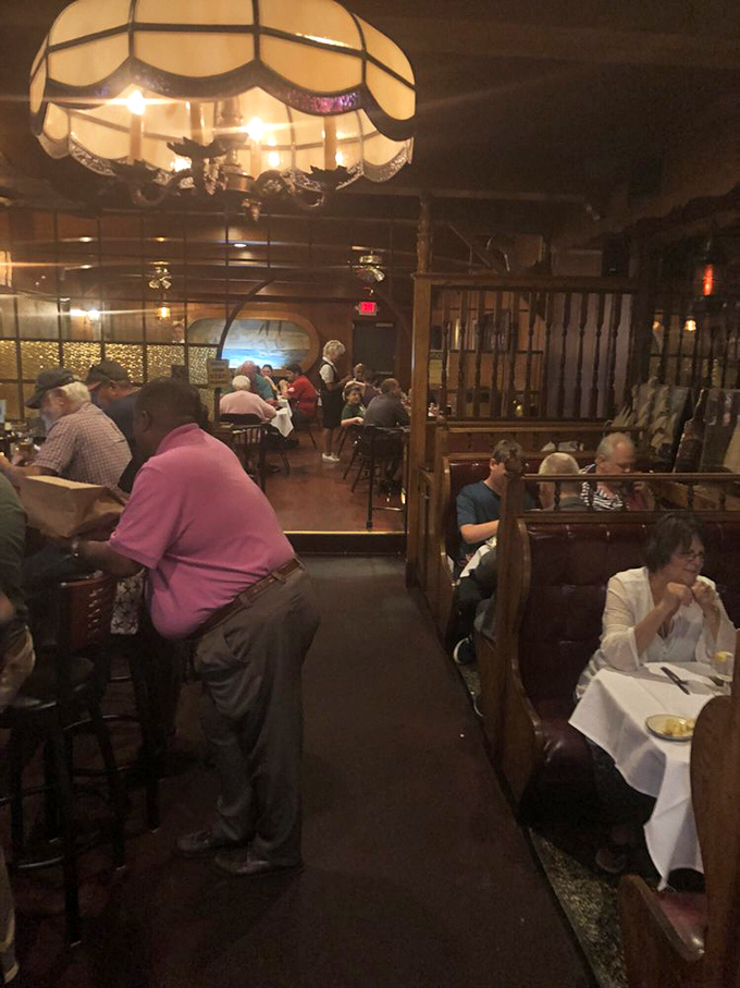 Where everybody knows your name... or at least your favorite cut of steak. Diners enjoying the warm, convivial atmosphere.