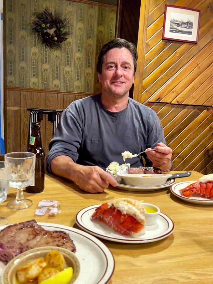 The image shows a person enjoying a meal at a table with various dishes spread out.