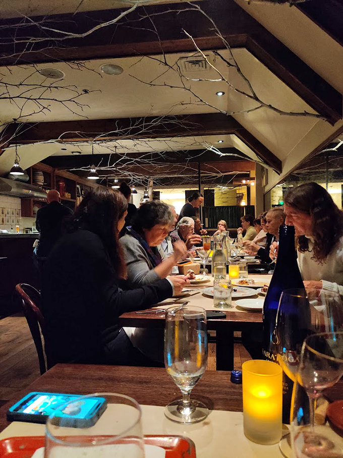 Happy diners basking in the glow of good food and even better company. This is what "breaking bread" is all about.