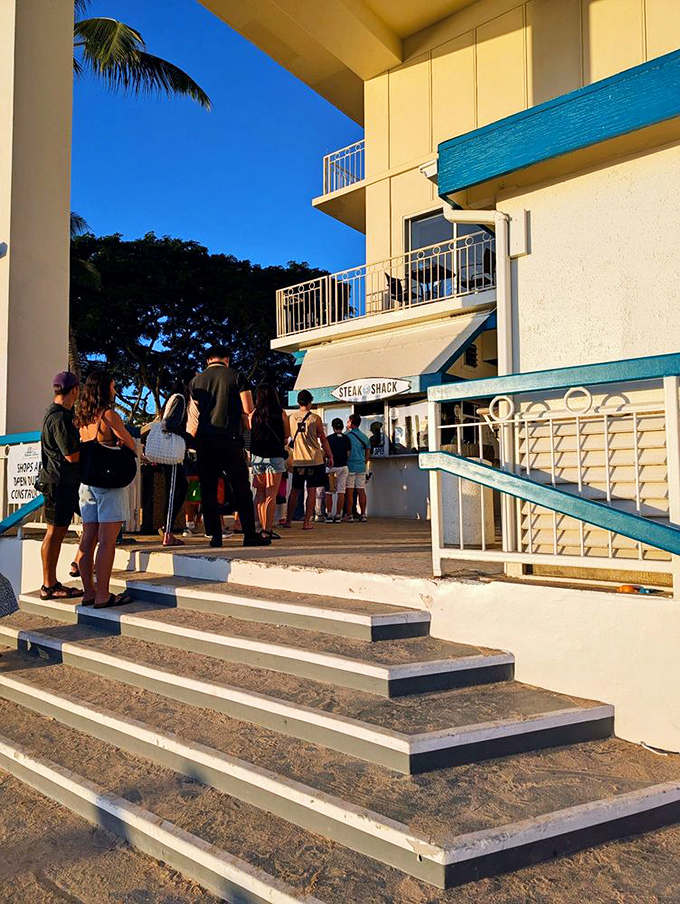 The line of anticipation! Like waiting for a roller coaster, but instead of loops, you get juicy steak at the end.