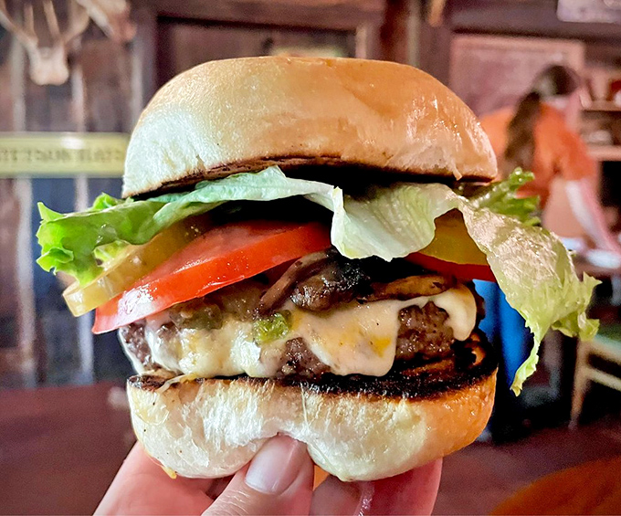 Hold onto your hats, folks! This burger is so tall and juicy, it should come with its own ladder and a warning label.