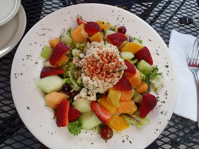 A fruit salad that's practically winking at you. Fresh, vibrant, and topped with what looks like the world's most perfect scoop of chicken salad.