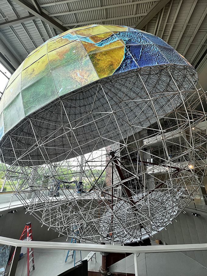 Eartha exposed! A rare glimpse into the globe's skeleton reveals the Herculean effort behind this geographical giant.