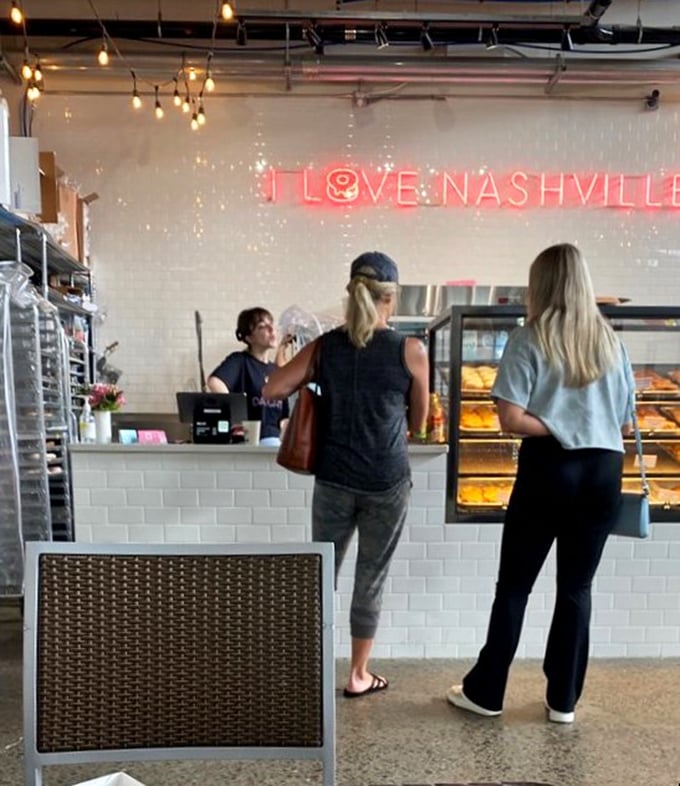 Where donut dreams come true! Customers eagerly await their turn to choose from an array of tempting treats. The struggle is real, folks.