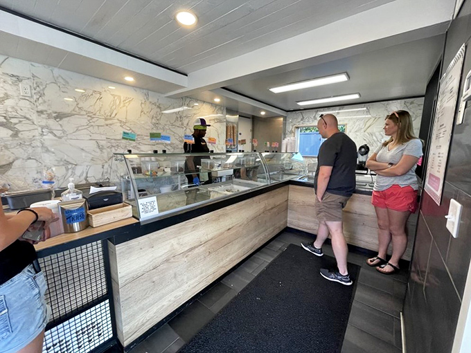 Ice cream social in progress! Watching folks choose their flavors is like observing an art form &ndash; delicious decisions in the making.