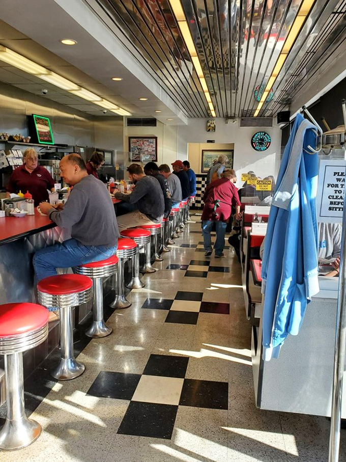 A scene straight out of Edward Hopper's "Nighthawks." These diners aren't just eating; they're participating in an American ritual.