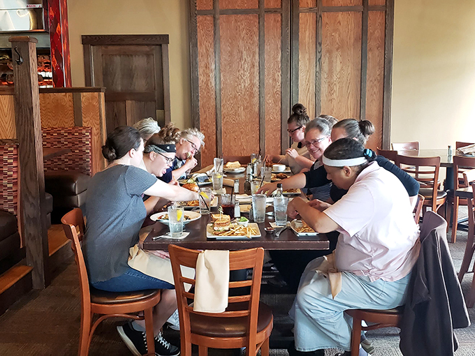 A snapshot of happiness: diners enjoying good food and even better company. It's like a Norman Rockwell painting, but with more cheese curds.