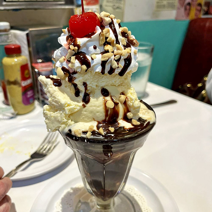 Behold, the Everest of ice cream! This towering sundae is a gravity-defying feat of engineering, crowned with a cherry that's practically winking at you.