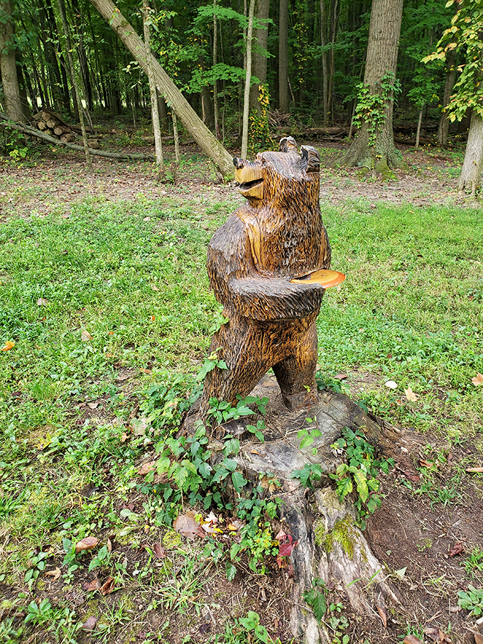 Who says bears can't be cultured? This wooden sculpture proves that even in the wilderness, there's always room for a little art appreciation.