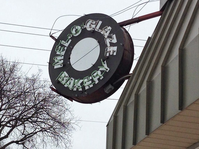 A sign from above... or at least from the side of the building. This vintage-style signage is like a bat signal for donut lovers, calling all sweet-toothed superheroes to assemble.