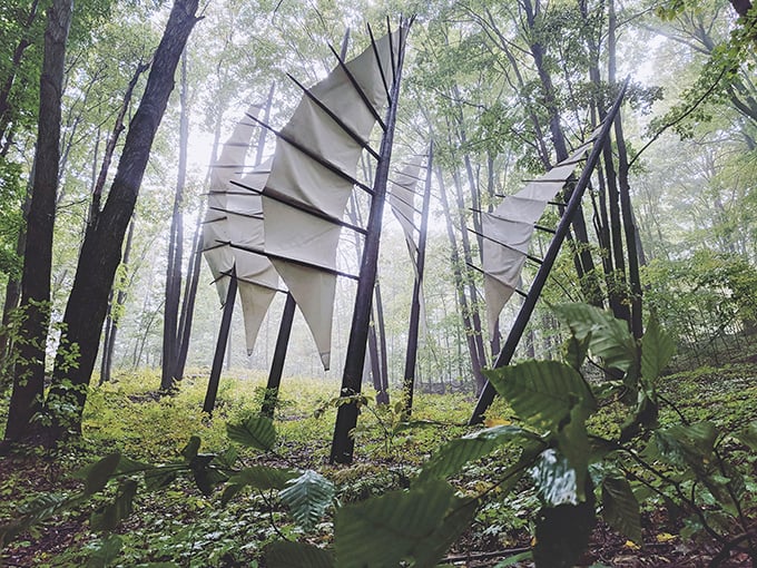 Metal origami in the woods! These sculptures play an intense game of hide-and-seek with the trees.