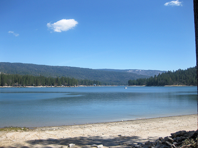 Sierra serenity: Bass Lake's clear waters and mountain views offer a perfect escape from the crowds.
