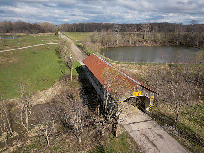 "Bird's eye bridge bliss." From up here, it's not just a covered bridge; it's nature's exclamation point on a landscape love letter.