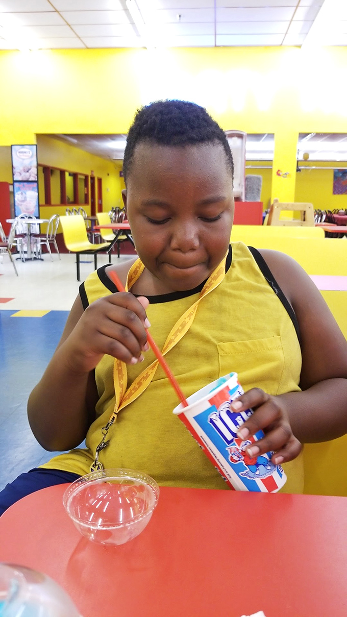 The face of pure bliss. Nothing says "victory lap" quite like a cold drink after conquering the arcade jungle. Savor it, champ!