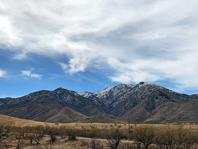 The majestic Dragoon Mountains stand guard over Tombstone, their peaks unchanged since the days of Wyatt Earp.