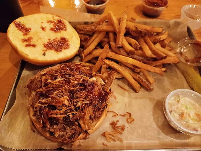 The pulled pork sandwich: Where 'messy' meets 'marvelous'. Napkins are not just recommended; they're essential equipment.