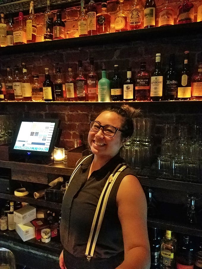 Behind every great cocktail is a great bartender. This mixologist's smile is as inviting as her carefully crafted concoctions.